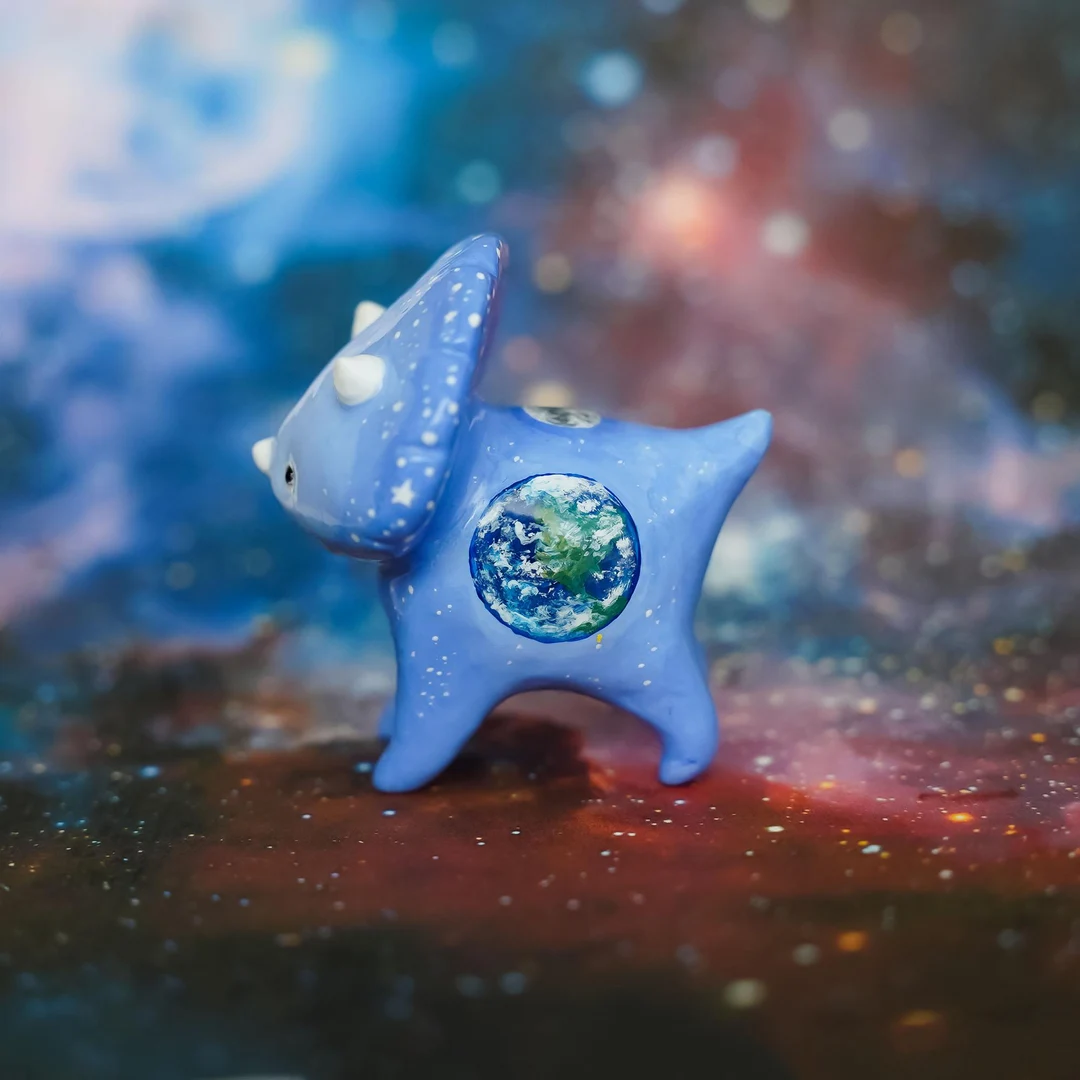 Triceratops with Earth, VallaVica, polymer clay and acrylic paints,2023 | Scrolller