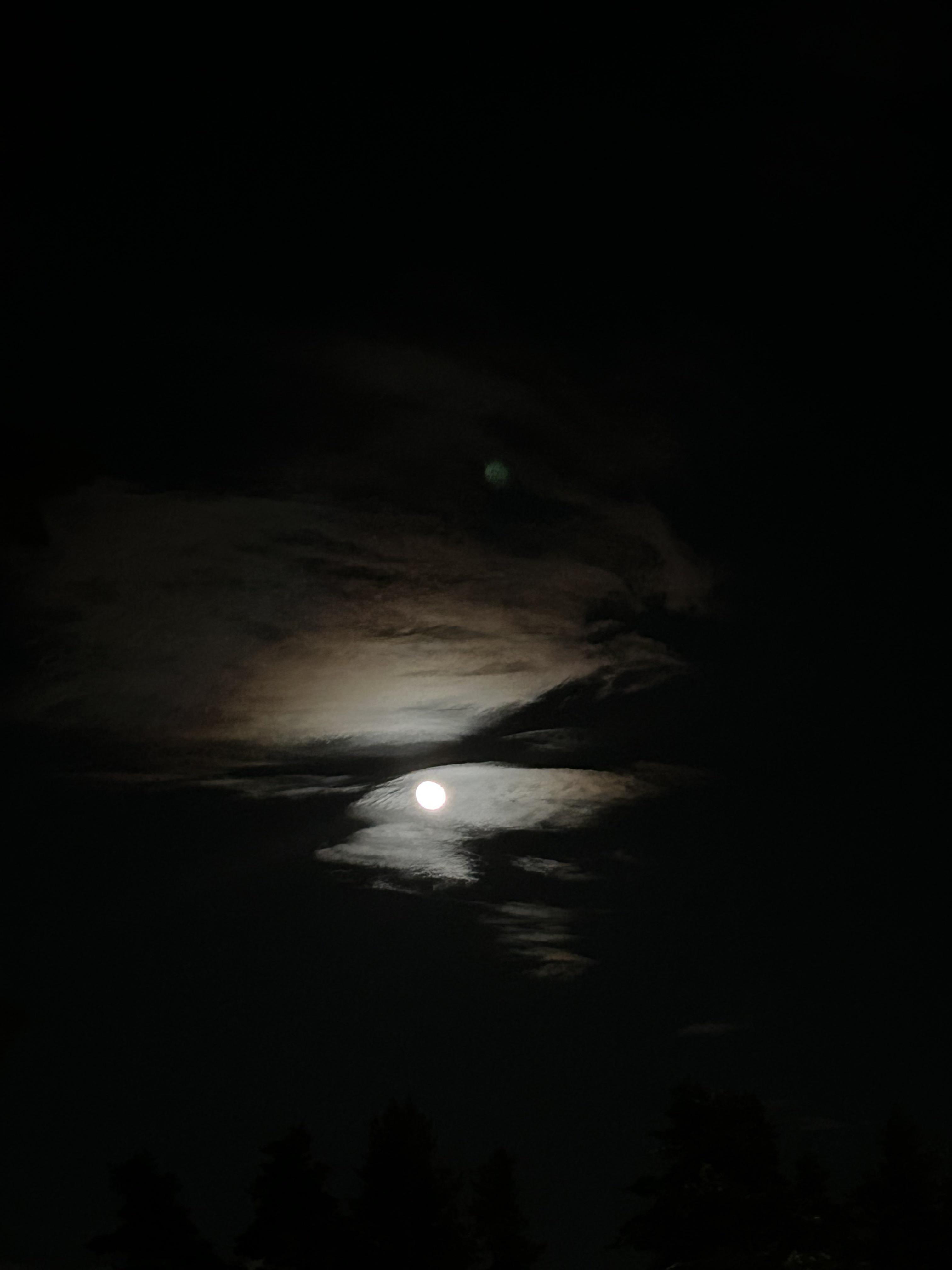 Moon shining through the clouds | Scrolller