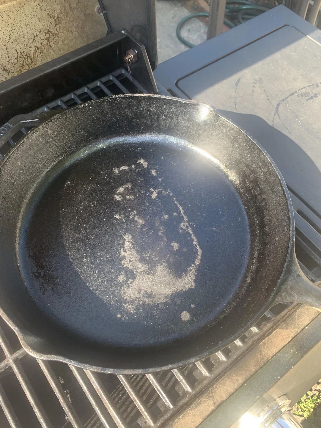 What caused this? Trying to season cast iron but the ghost of the steak I cooked is still there ...