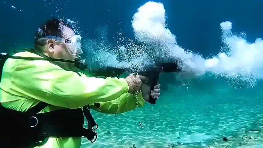 Firing a submachine gun underwater | Scrolller