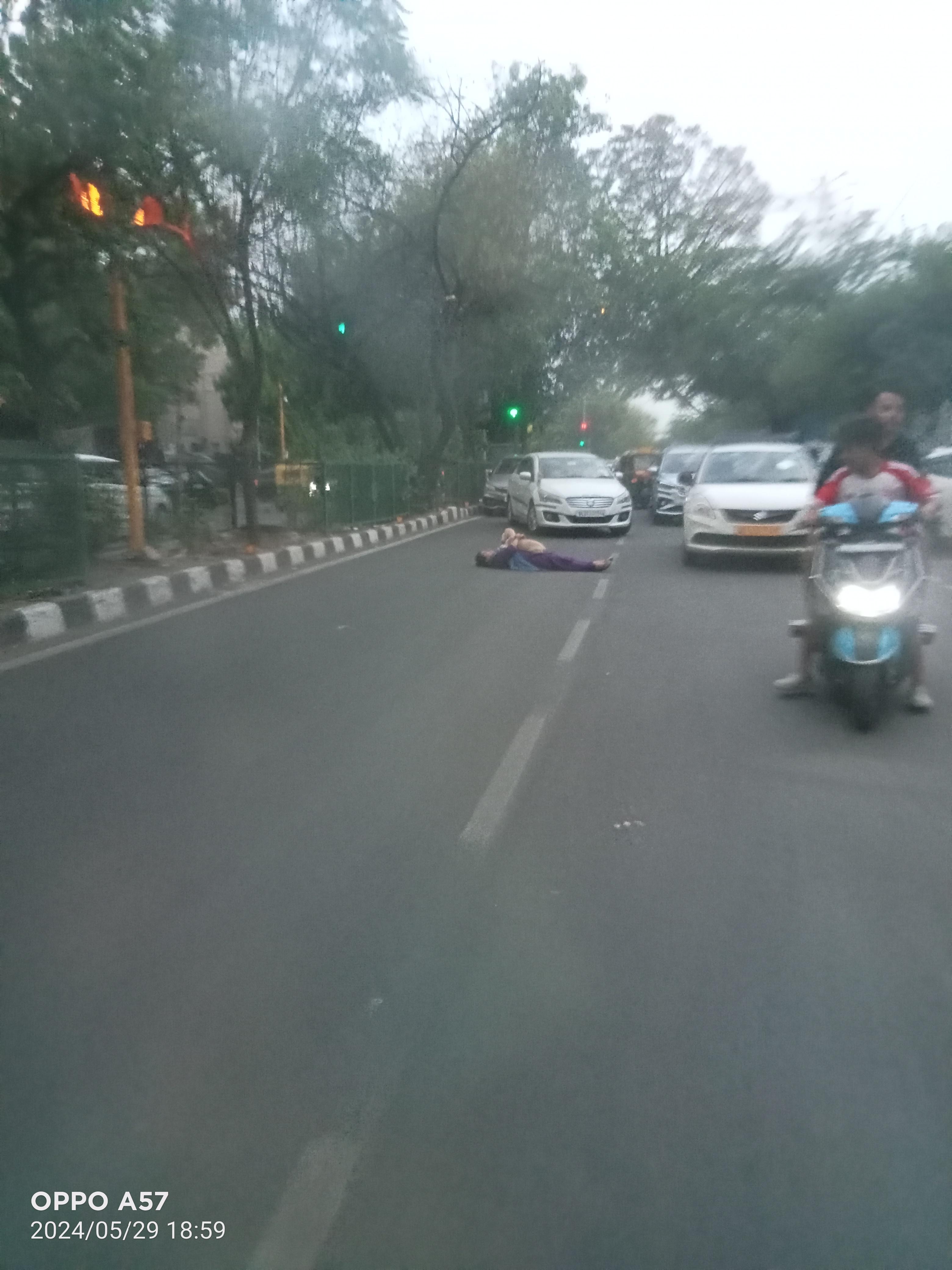 Lady Laying on the Road | Scrolller