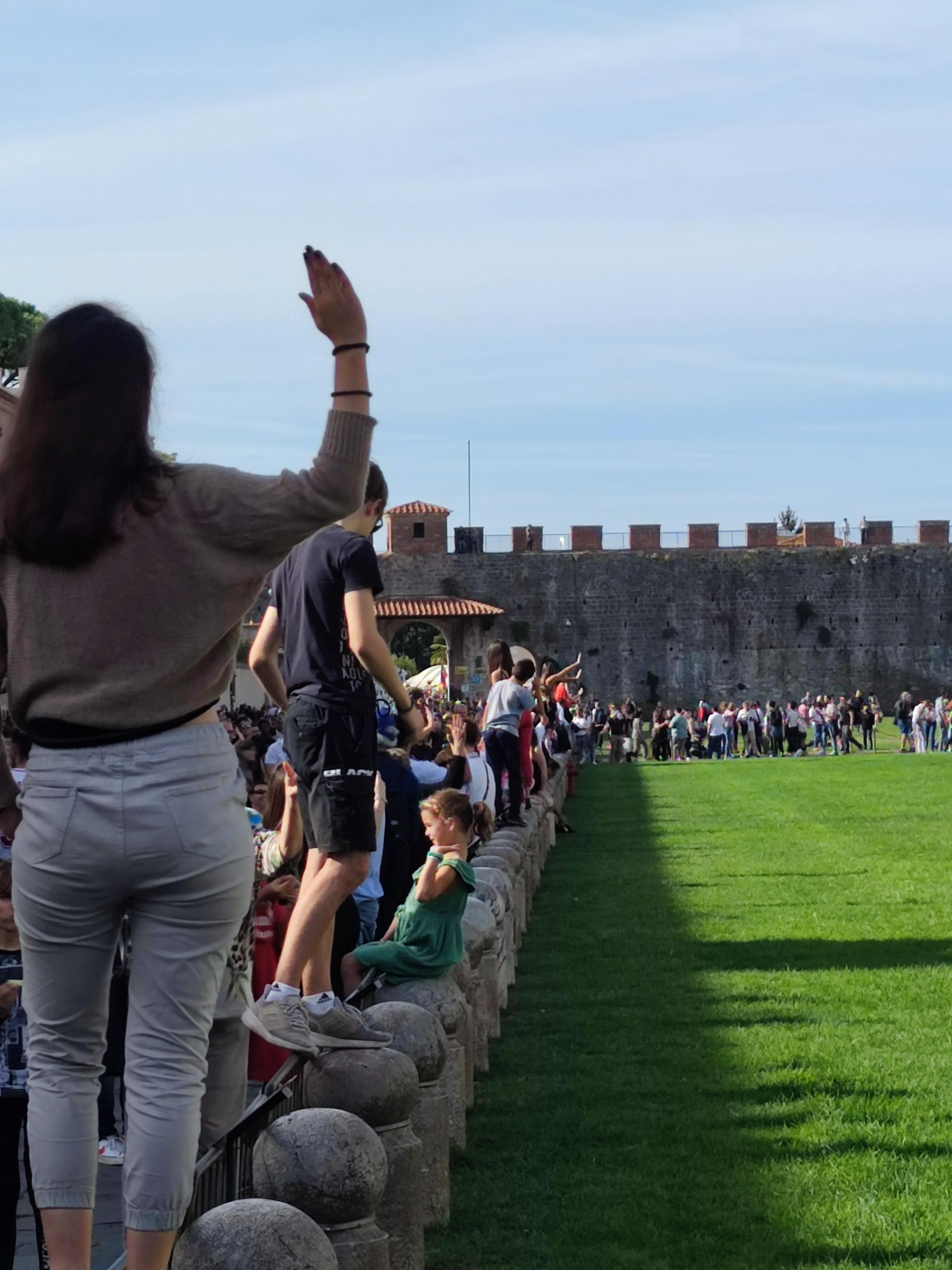 Lots of people posing as touching the Leaning Tower of Pisa | Scrolller