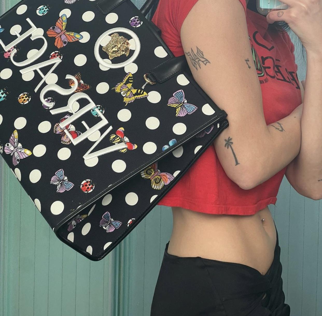 Showing off her Versace purse (via IG June 2023) | Scrolller