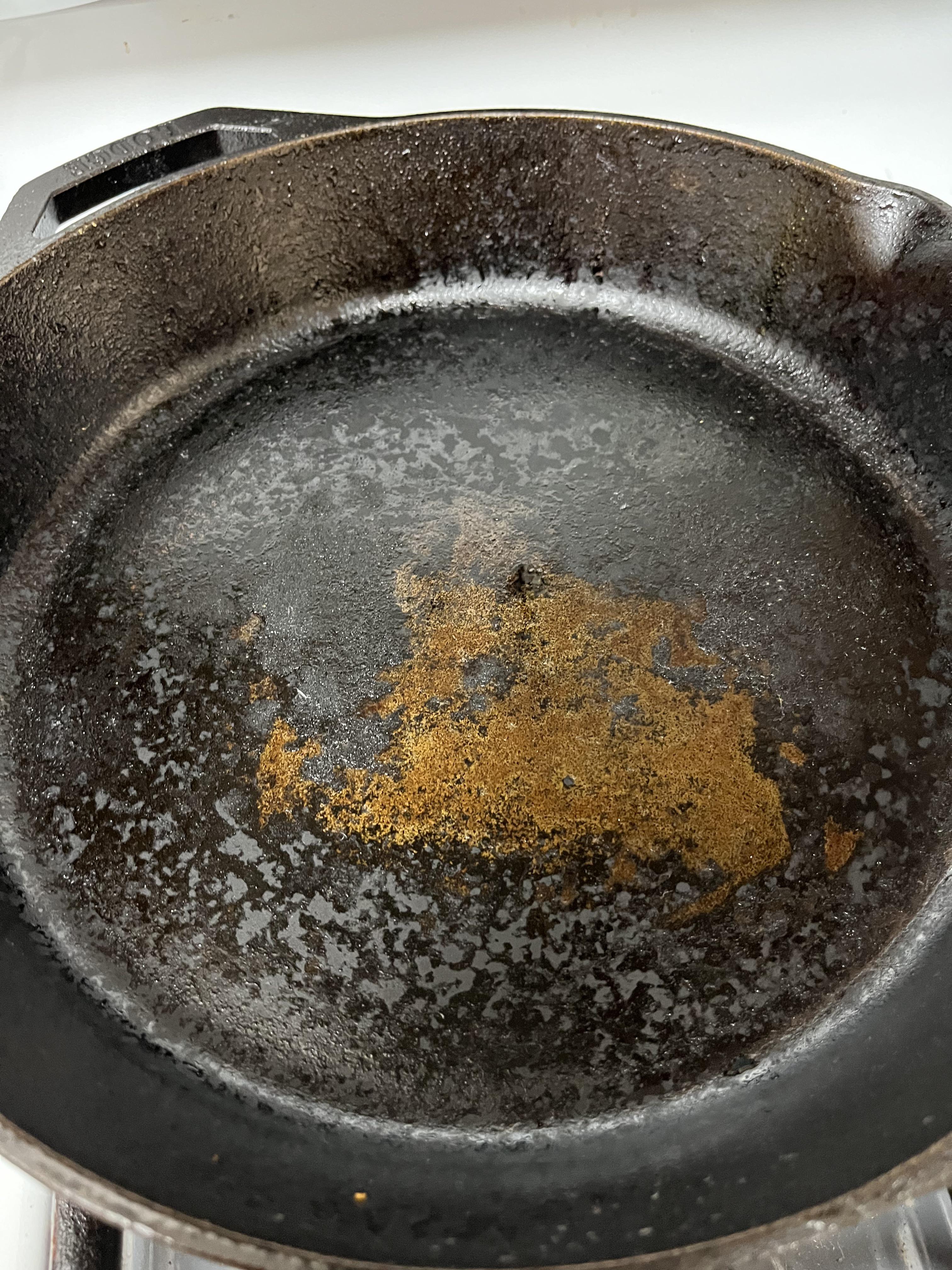 How can I fix this? Food was super stuck on so I boiled water in it and then tried to reseason a ...