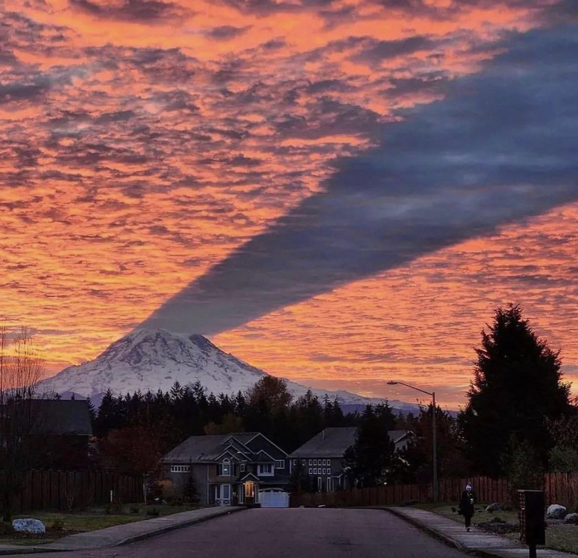 The shadow of Mount Rainier causes a gap in the sunset | Scrolller
