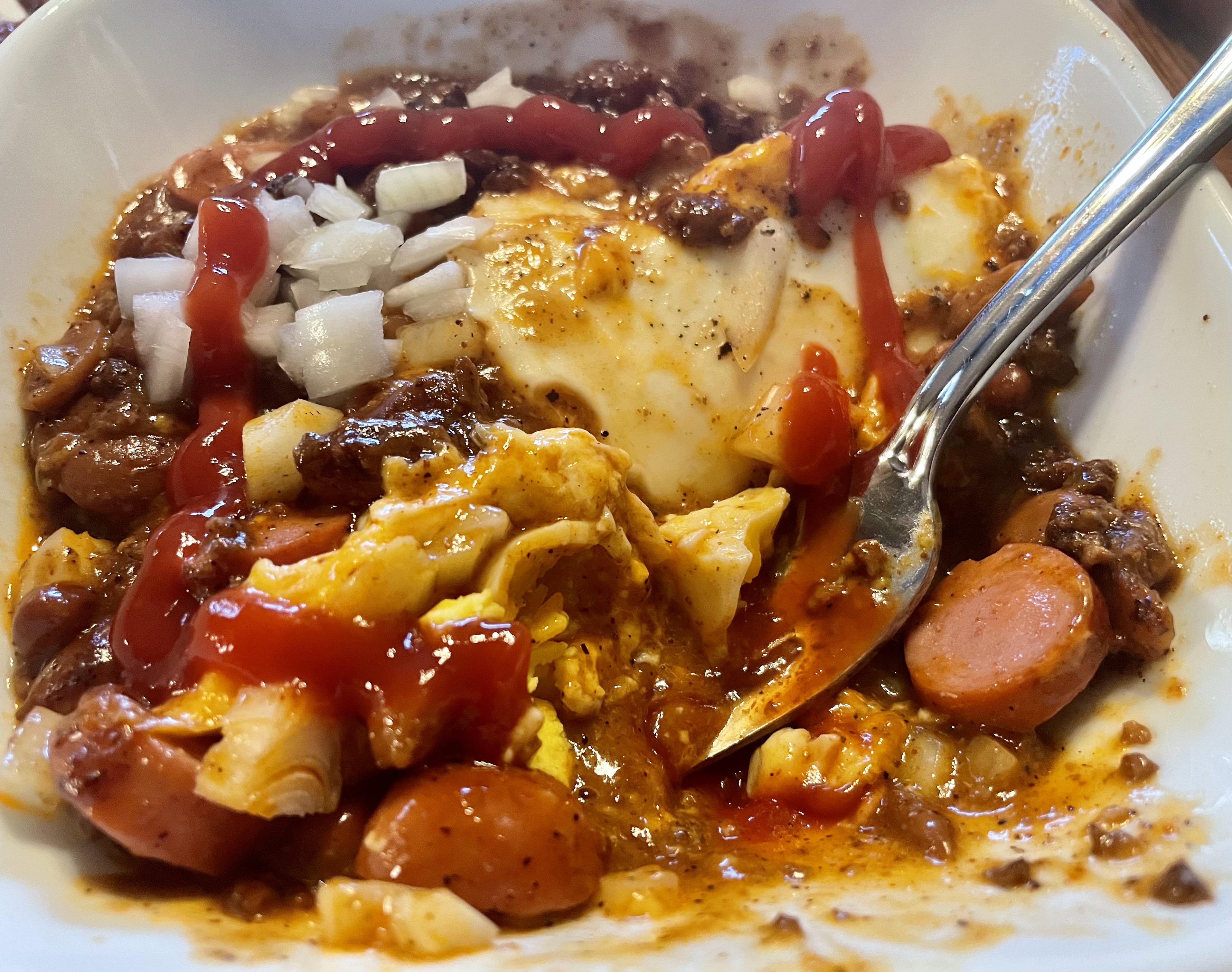 [i ate] eggs over chile and sliced hotdog, with cheese and onions. | Scrolller