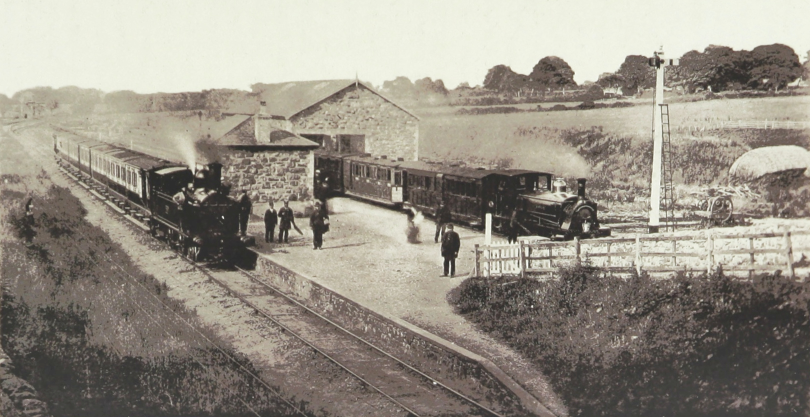 Dinas station in 1883. A NWNGR train with Beddgelert and a LNWR train are waiting on the ...
